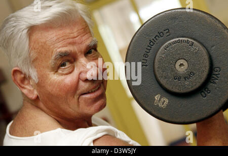 76 year-old bodybuilder Walter Klock works out with a barbell at a gym ...