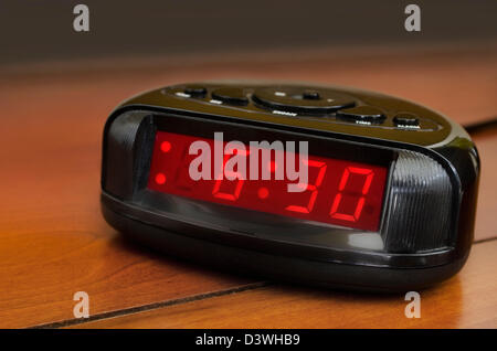 Red alarm clock on wood table with blur nature background and copy ...