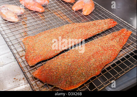 Salmon and cod roe being prepared to be smoked at a smoke house in the ...
