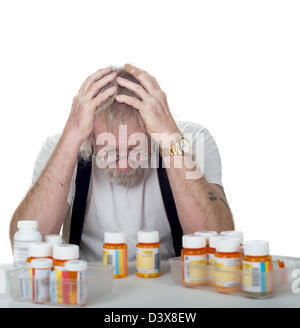 Senior man holding pharmaceutical pills over isolated background with ...