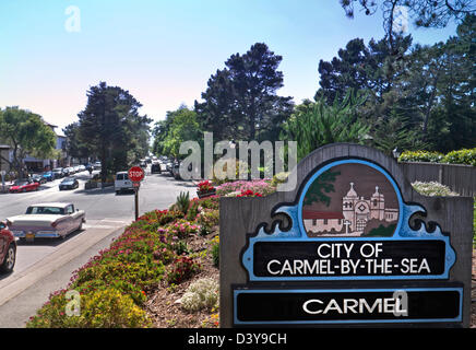 CARMEL BY THE SEA Sign at entrance to Carmel Village with tourist ...