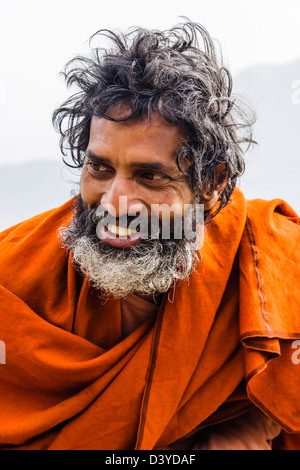 Wandering sadhu baba (holy man) with traditional long hair in ancient ...