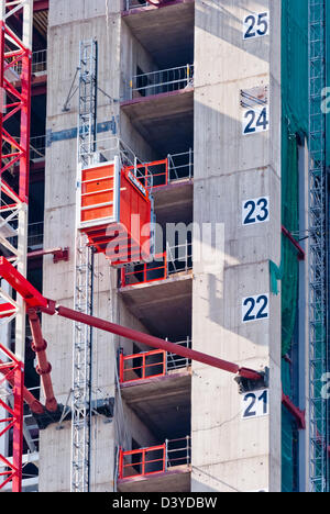 Worker in construction elevator lift Stock Photo - Alamy