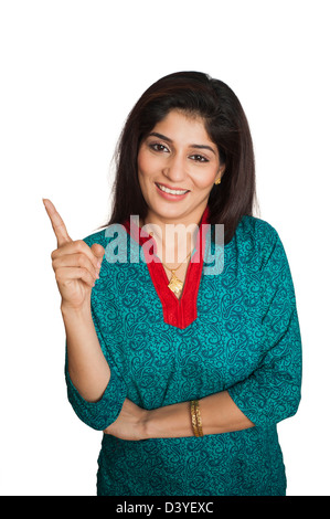 Portrait of happy asian woman pointing fingers down and looking below ...
