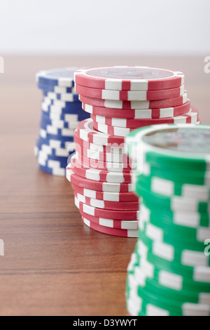 A top view of stacks of poker chips with money on a black table Stock ...