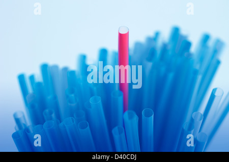 Plastic straws with one standing out Stock Photo - Alamy