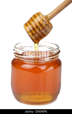 honey pouring in jar isolated Stock Photo - Alamy