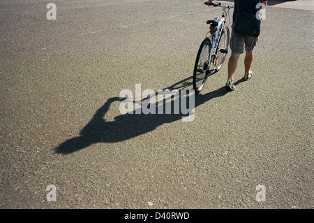 Long shadows of a person pushing a bike, Berlin, Germany Stock Photo ...