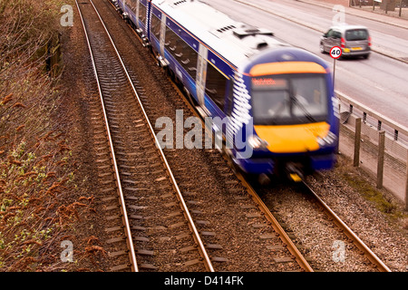 a speeding fast train approaching an automatic half barrier level crossing operated by network ...