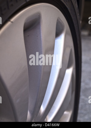 Grey modern cast disc alloy wheel on black background Stock Photo - Alamy