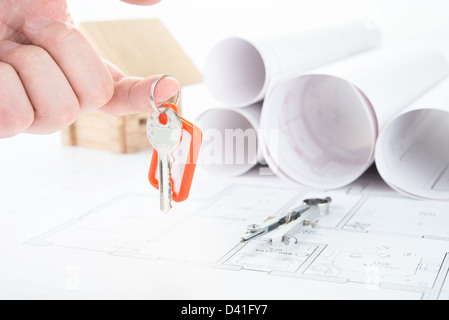Blueprints hand with keys Stock Photo - Alamy