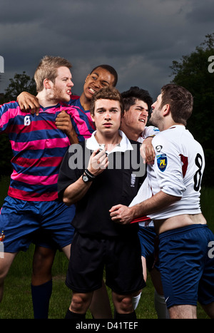Football referee standing in front of a couch and cheering with hands ...
