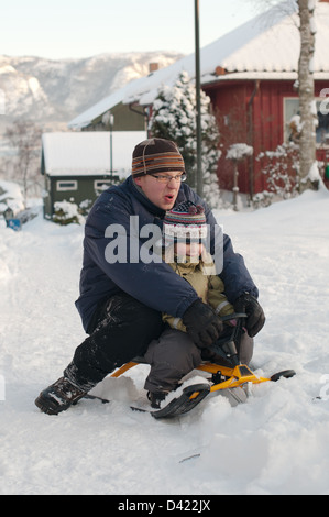 Kid fooling around on father back during floor washing Stock Photo - Alamy