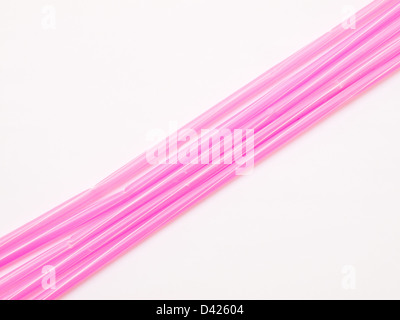 Pink straws isolated on white background Stock Photo - Alamy