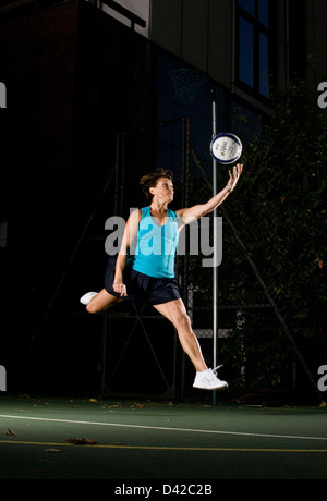 Netball player jumping to reach the ball Stock Photo - Alamy