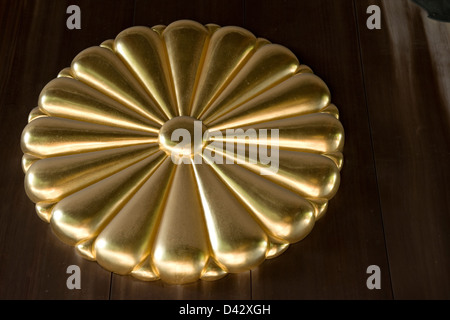 Imperial Seal of Japan, the Chrysanthemum, on the wooden door of the ...
