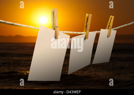 Note papers hooked on a rope. Straw background Stock Photo - Alamy