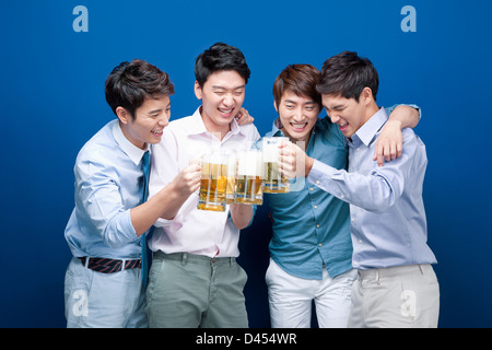 Businessmen toasting with beer Stock Photo - Alamy