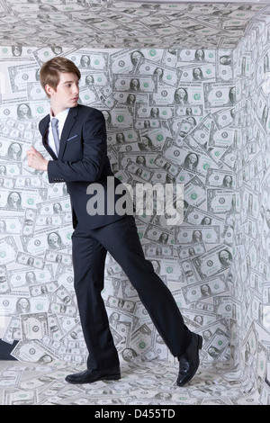 Businessman running away from dollar ball Stock Photo - Alamy