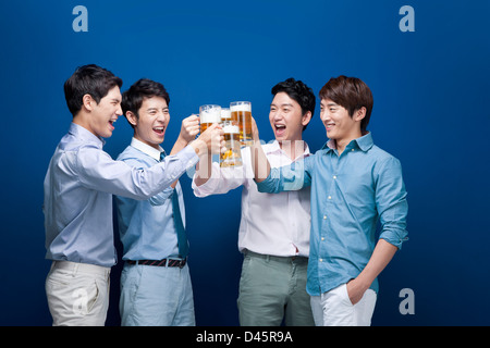 four businessmen toasting with beer Stock Photo - Alamy