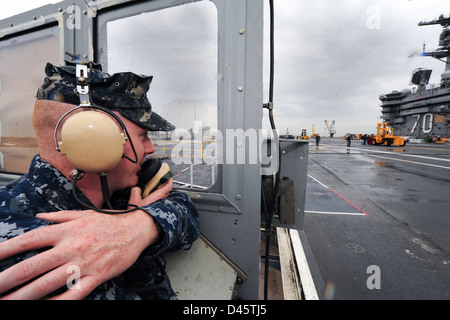 A US Navy sailor talks on an early stick telephone, ca. 1930 Stock ...