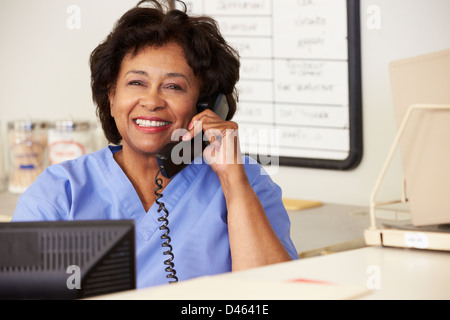 Nurse Making Phone Call At Nurses Station Stock Photo - Alamy