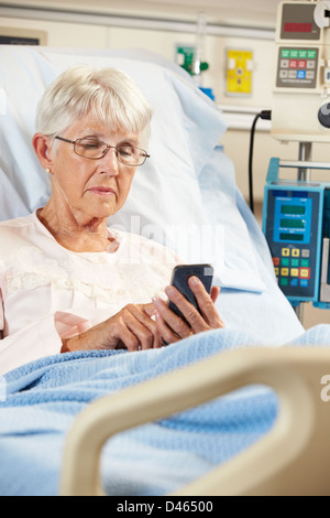 Female hospital patient using cellphone Stock Photo - Alamy