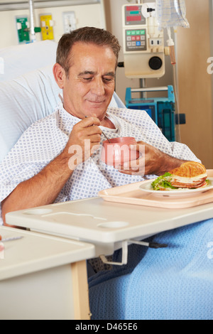 The male patient eating food in the hospital Stock Photo - Alamy