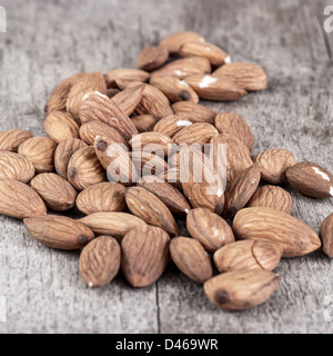 Roasted almonds on wooden table Stock Photo - Alamy