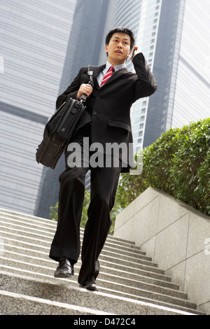 man rushing by with mobile phone Stock Photo - Alamy