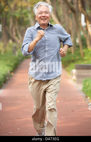 One active Asian Chinese senior male man taking photographs with his ...
