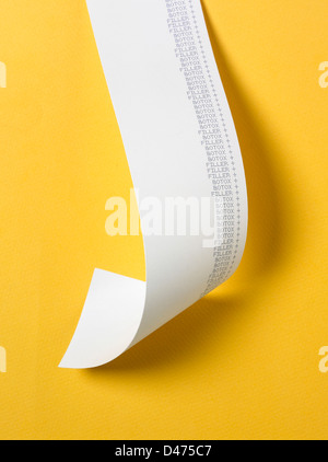 Strip of receipt cut out yellow background Stock Photo - Alamy