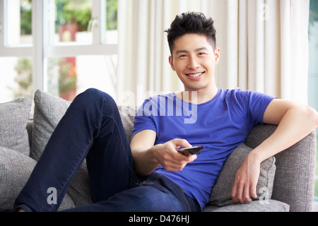 Young man watching tv at home Stock Photo - Alamy