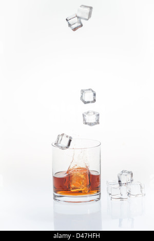 falling glass of brandy with splash isolated on white Stock Photo - Alamy
