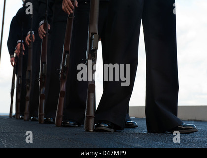 A US Navy sailor stands at parade rest during a uniform inspection ...