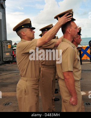A new chief receives their combination cover during a ceremony in ...