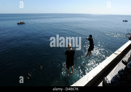 Sailors jump to the sea during a swim call aboard USS Carl Vinson Stock ...