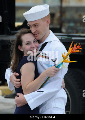 US Navy A Sailor hugs his wife following the ship's return to Naval ...