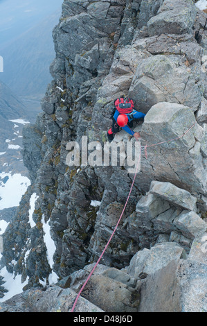 Climber descends into a gap on a classic Ben Nevis route Tower Ridge ...
