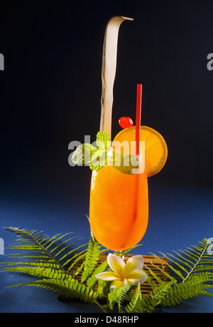 A Tropical Itch Cocktail Garnished With Fruit And A Backscratcher Stock ...