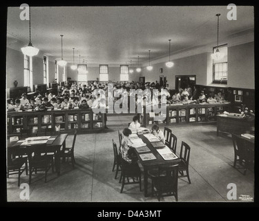 A 1920 photograph from a library extension program showing a child ...
