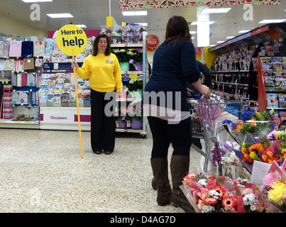 Employee helping a customer Stock Photo - Alamy
