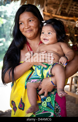 Embera indian woman and child at the Embera Puru village, Rio Pequeni, Panama province, Republic ...