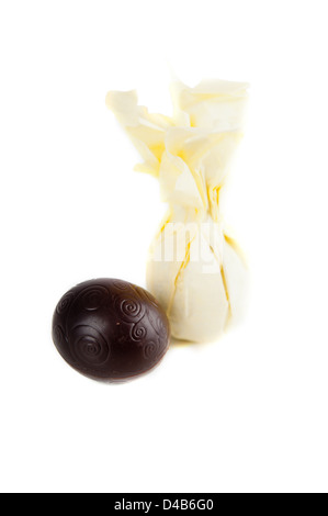 chocolate candy without the wrapper, near chocolate sweets on a white ...
