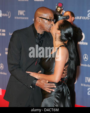 US former track and field champion Edwin Moses (L) and his wife ...