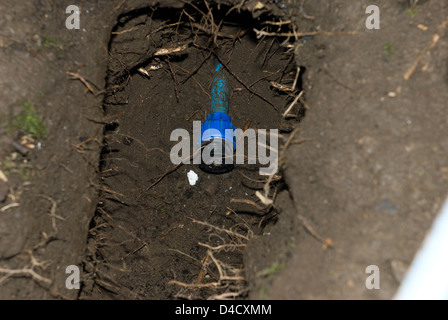 A blue alkathene water pipe capped off in a trench Stock Photo - Alamy