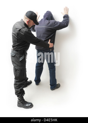 Police, crime and search with suspect being arrested in a street ...