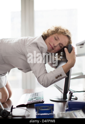 Woman hugging computer monitor Stock Photo - Alamy