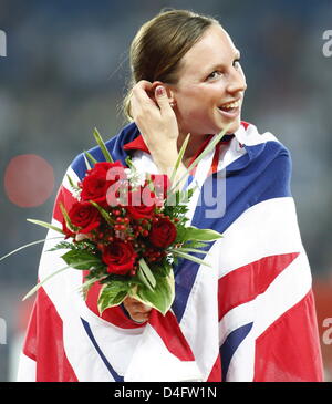 Heather Fell of Great Britain celebrates as she crosses the finish line ...