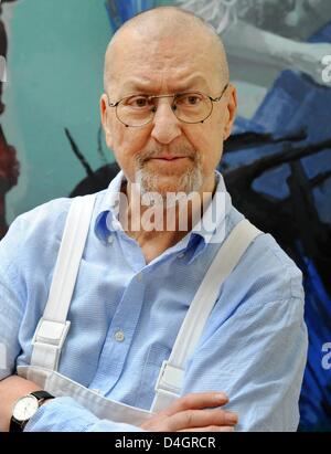Painter Arno Rink sits in front of his new work 'Jagd' ('Hunt') in his ...